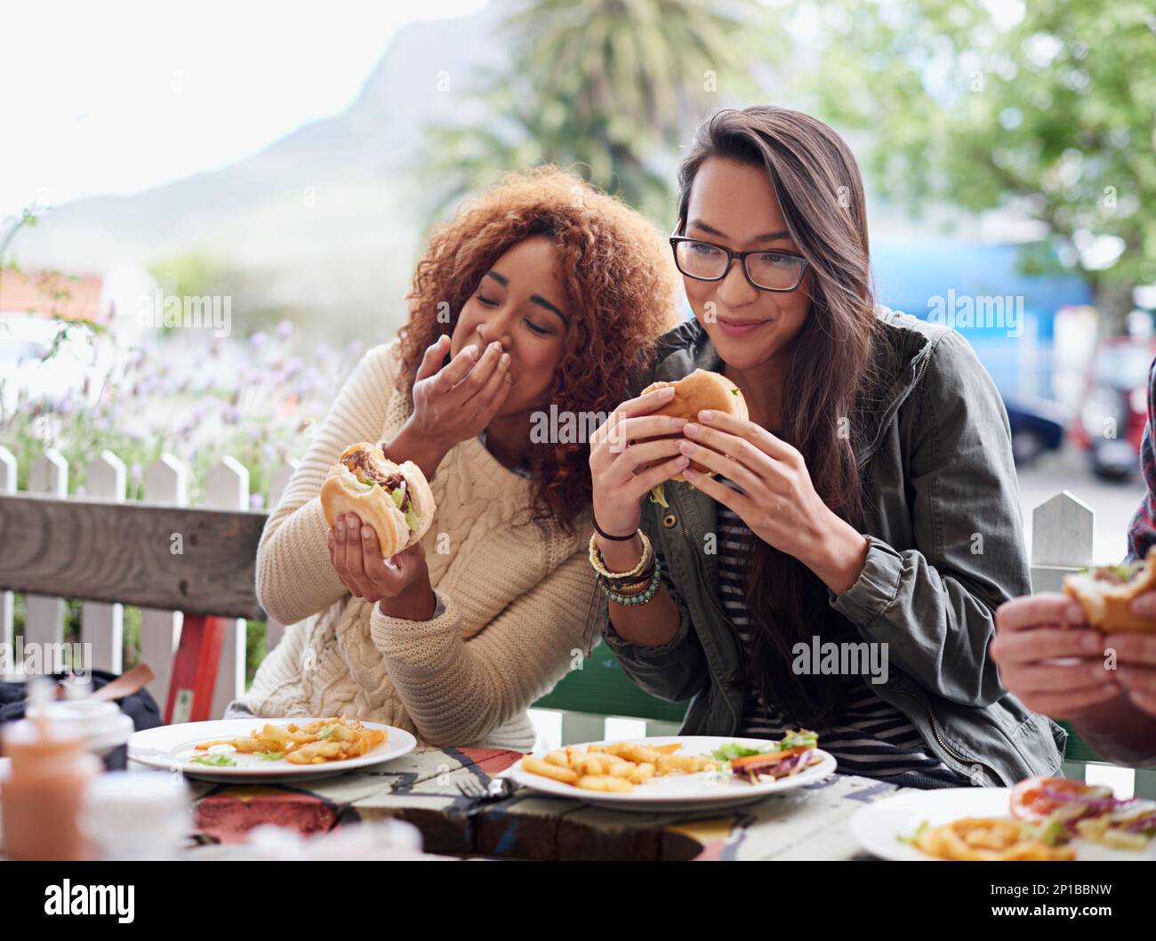Brunette burger outdoor eating young hi-res stock photography and ...