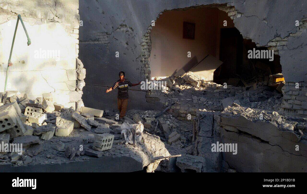 A man navigates the rubble of a destroyed home after a bombing in ...