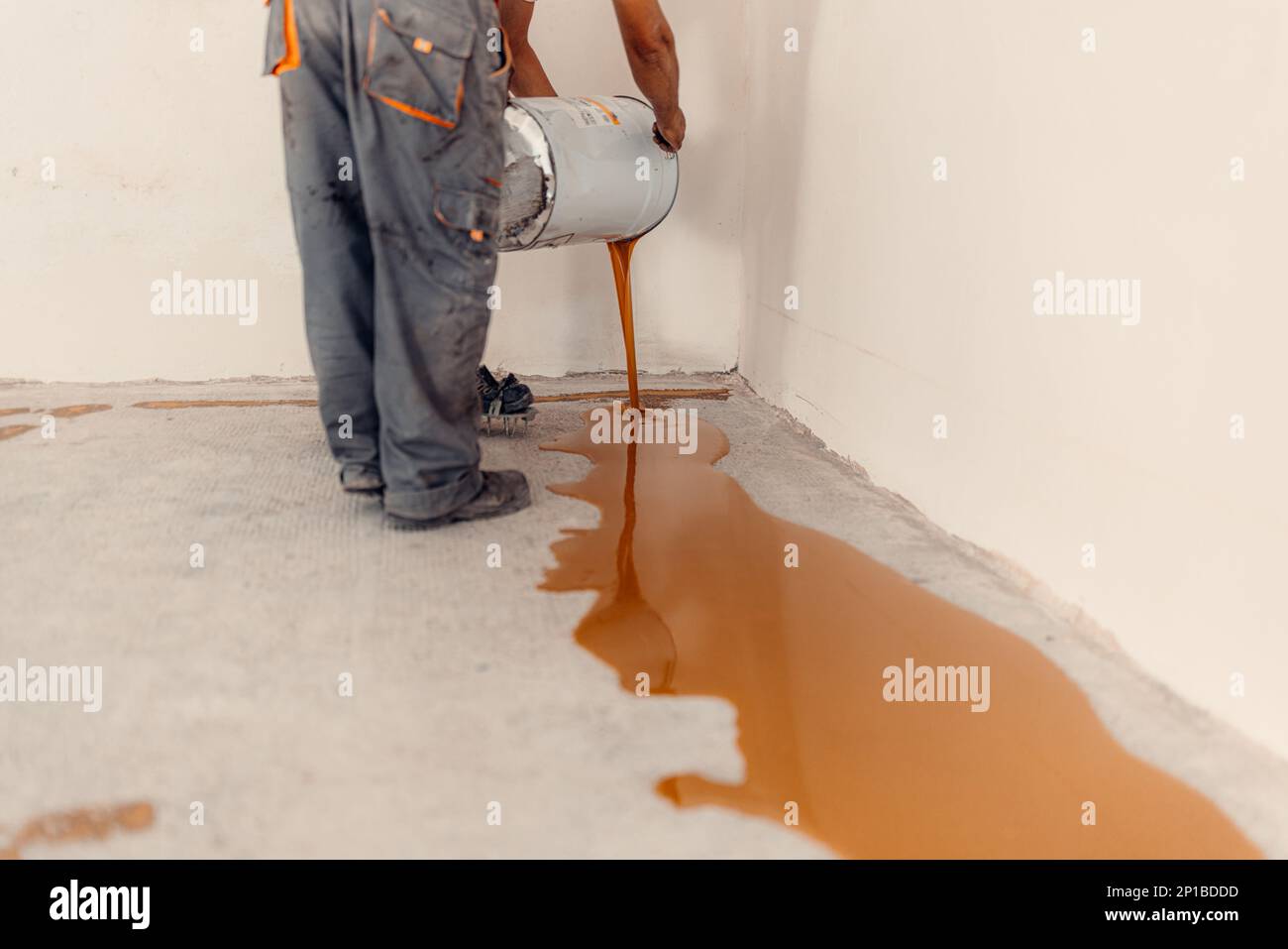 An worker applying a yellow epoxy resin bucket on floor Stock Photo - Alamy