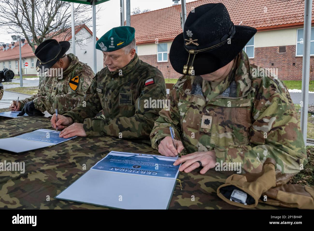 From left, U.S. Army Lt. Col. James Ray, incoming commander of NATO eFP ...