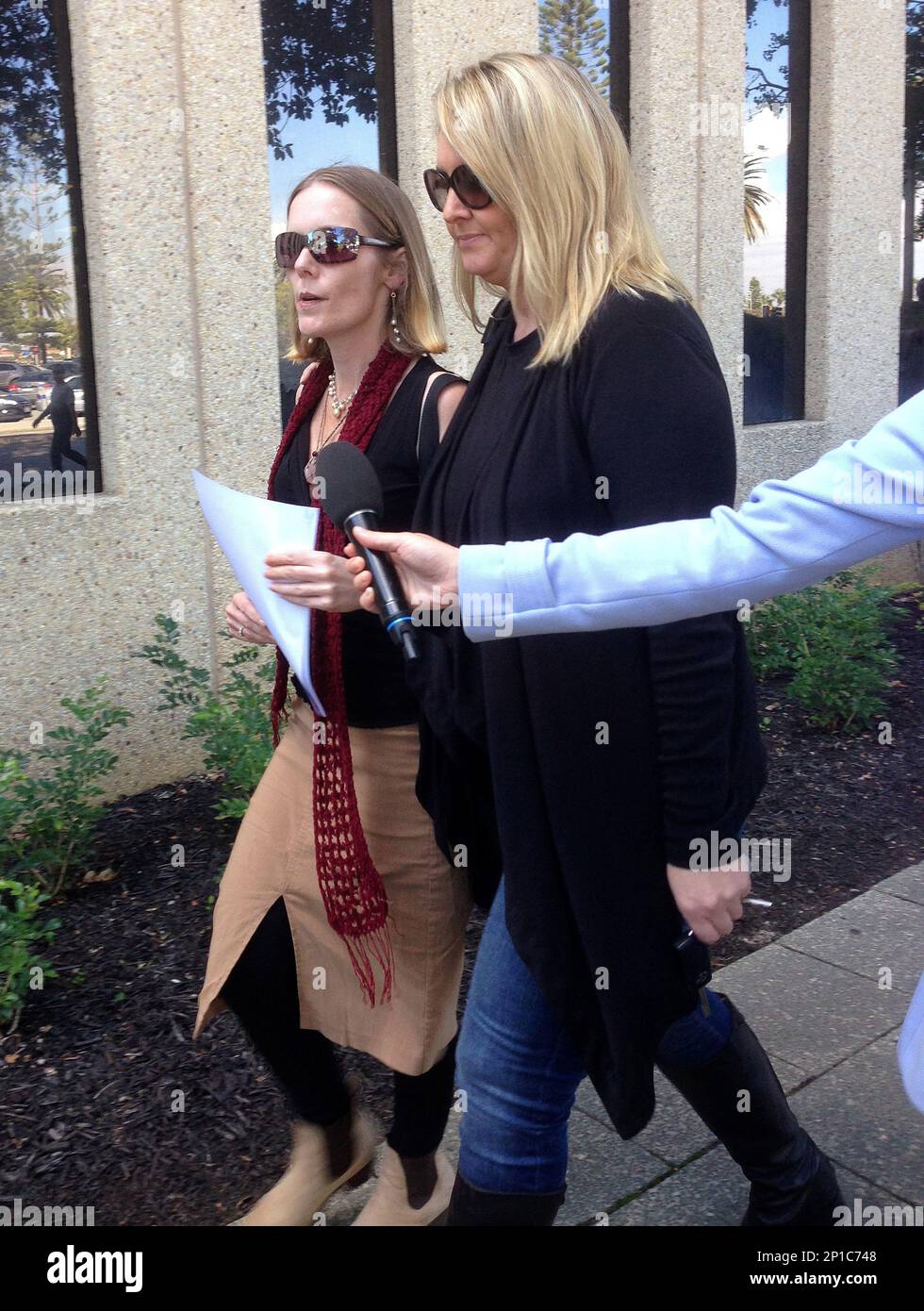 Angela Kiszko, left, walks with an unidentified woman after leaving a ...