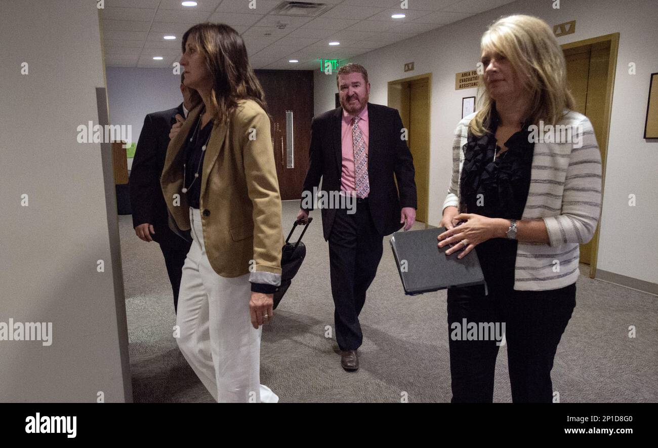 Public defender Dan King, center, arrives for the competency hearing ...