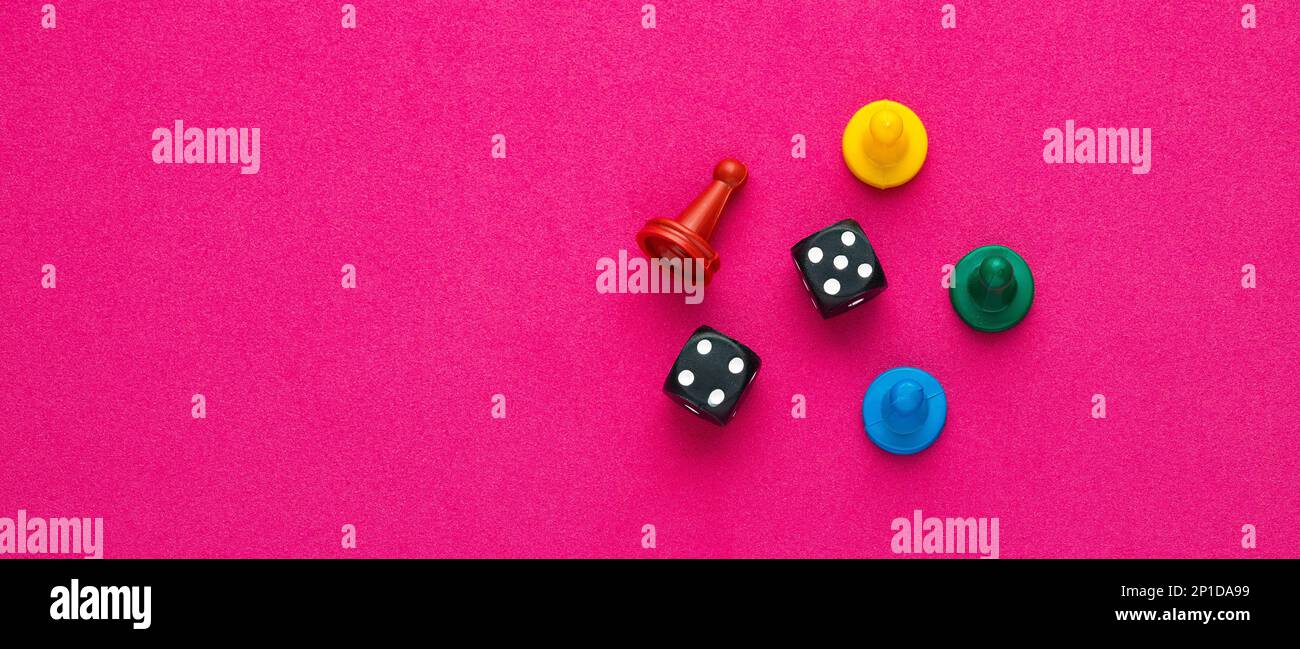 Board game pieces and dice - Rhodamine red eva rubber background Stock ...
