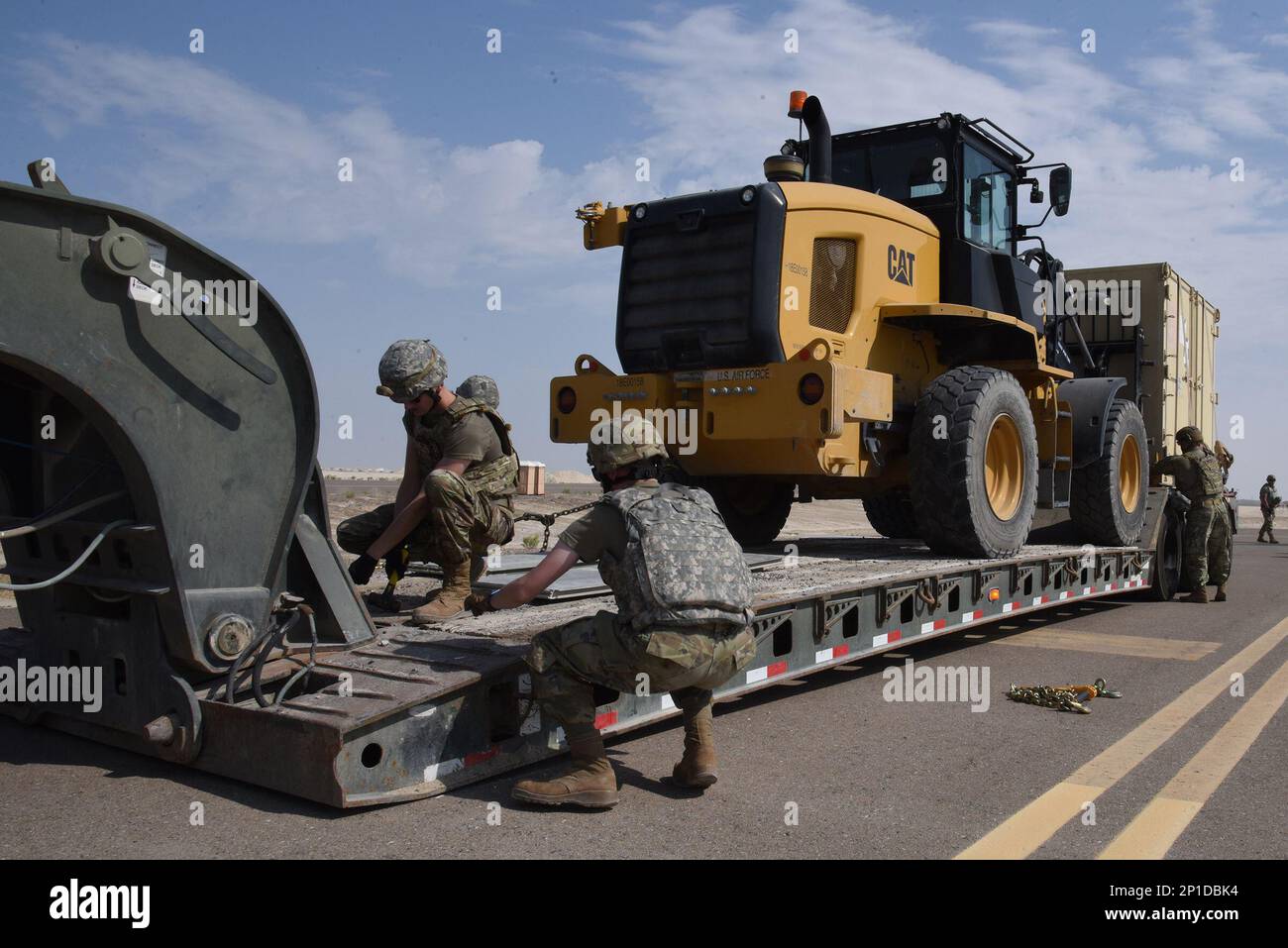 Members of Multi Capable Airmen Team 2 unsecure a CAT heavy forklift ...
