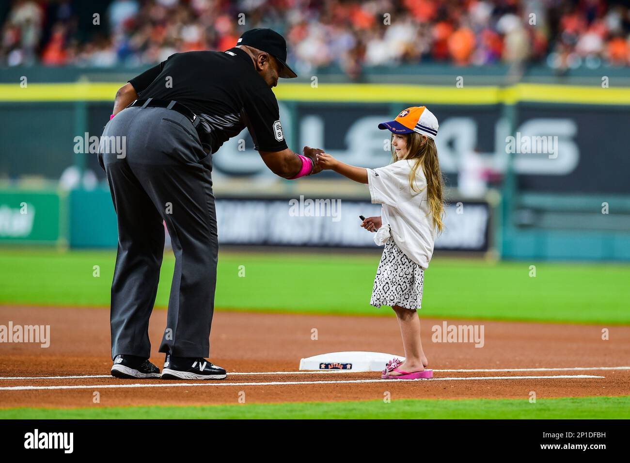 May 08, 2016: The first base umpire fist bumps a young fan at first ...