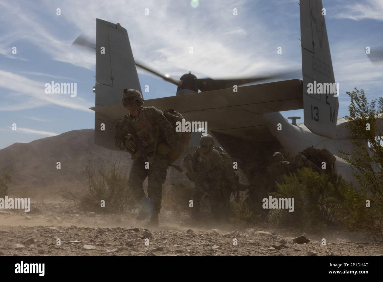 U.S. Marines with 3rd Battalion, 5th Marine Regiment, 1st Marine Division, exit an MV-22B Osprey ...