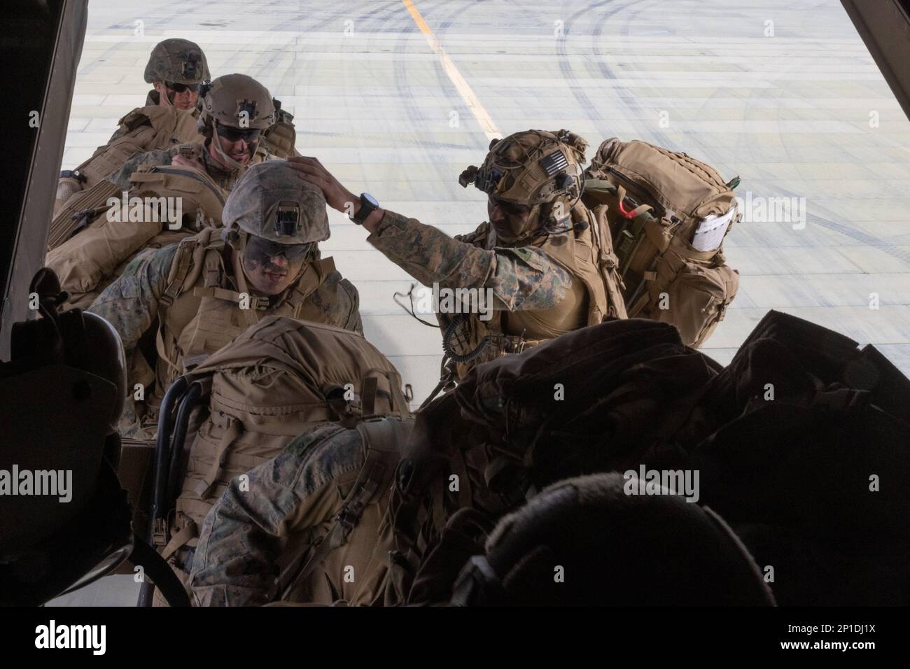 U.S. Marines with 3rd Battalion, 5th Marine Regiment, 1st Marine Division, get into an MV-22B ...