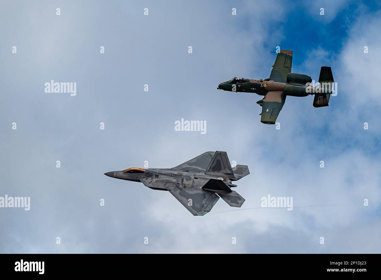 A U.S. Air Force A-10C Thunderbolt II flies alongside an F-22 Raptor ...