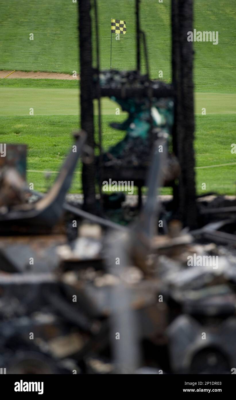 A green flag can be seen through the remains of Bent Creek Golf Course ...