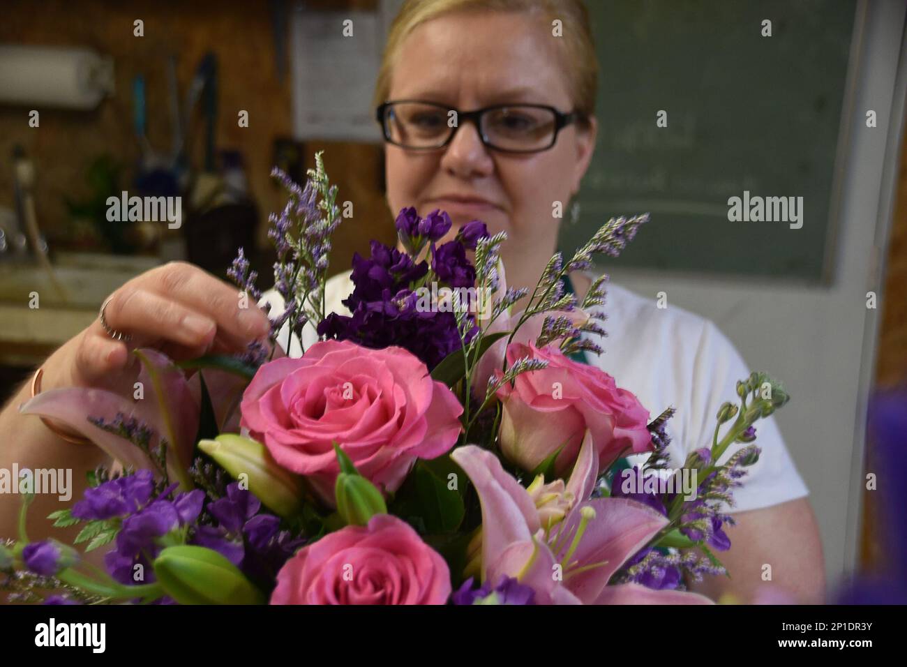 Christy Meng, a florist at Dee’s Flowers, works on bouquets at the ...