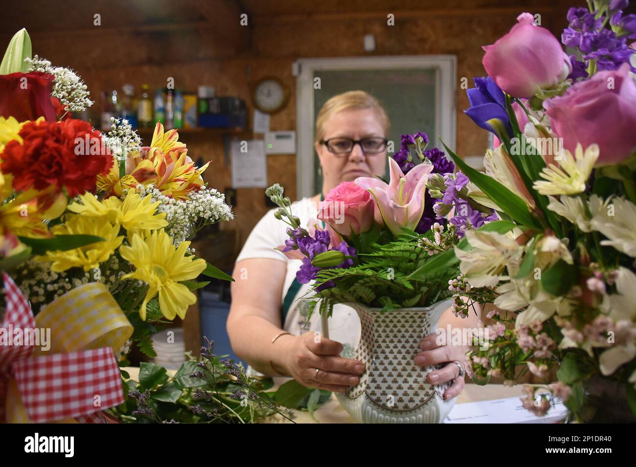 Christy Meng, a florist at Dee’s Flowers, works on bouquets at the ...