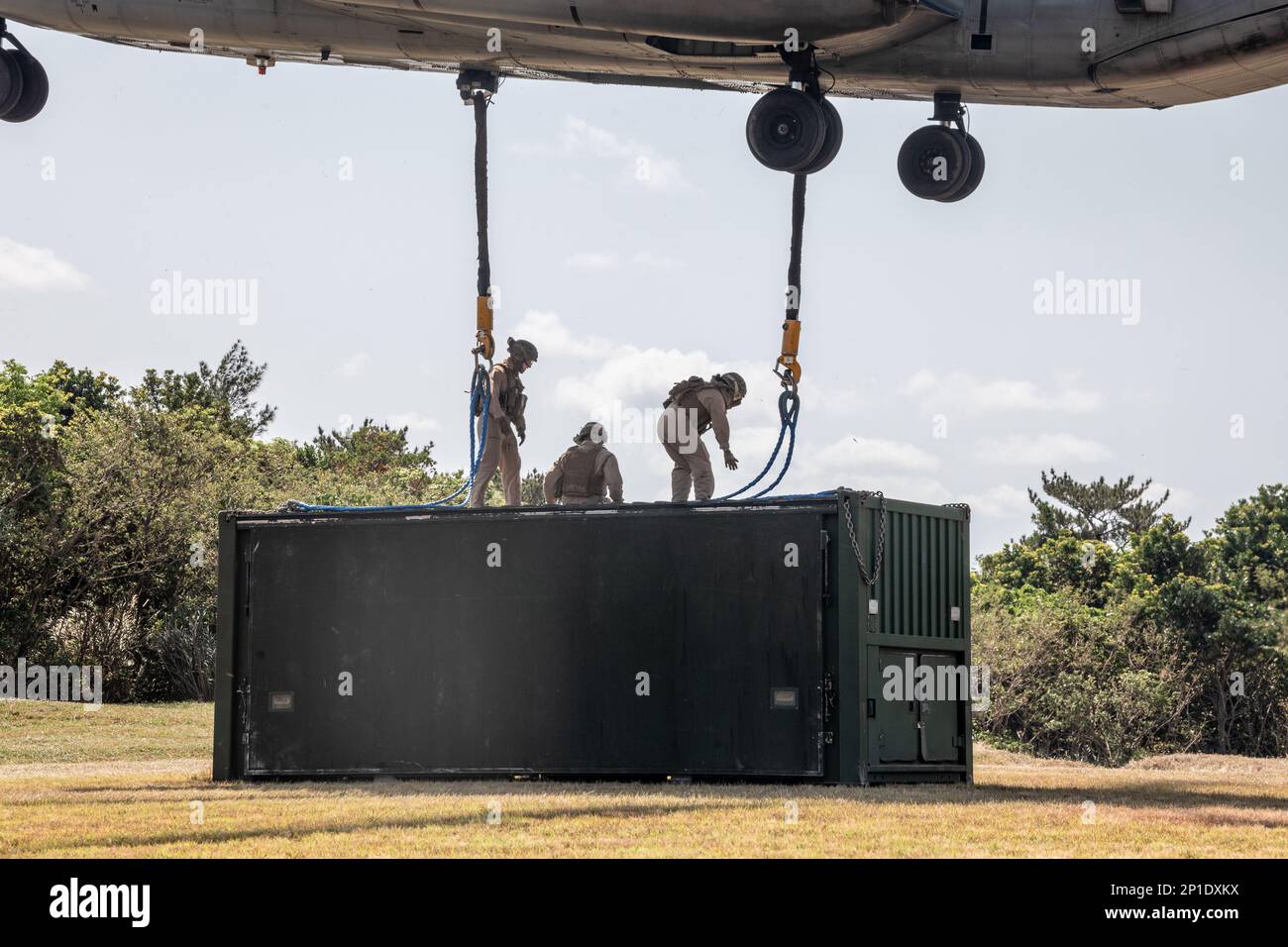 U.S. Marines with 3rd Landing Support Battalion attach a Shop Equipment ...
