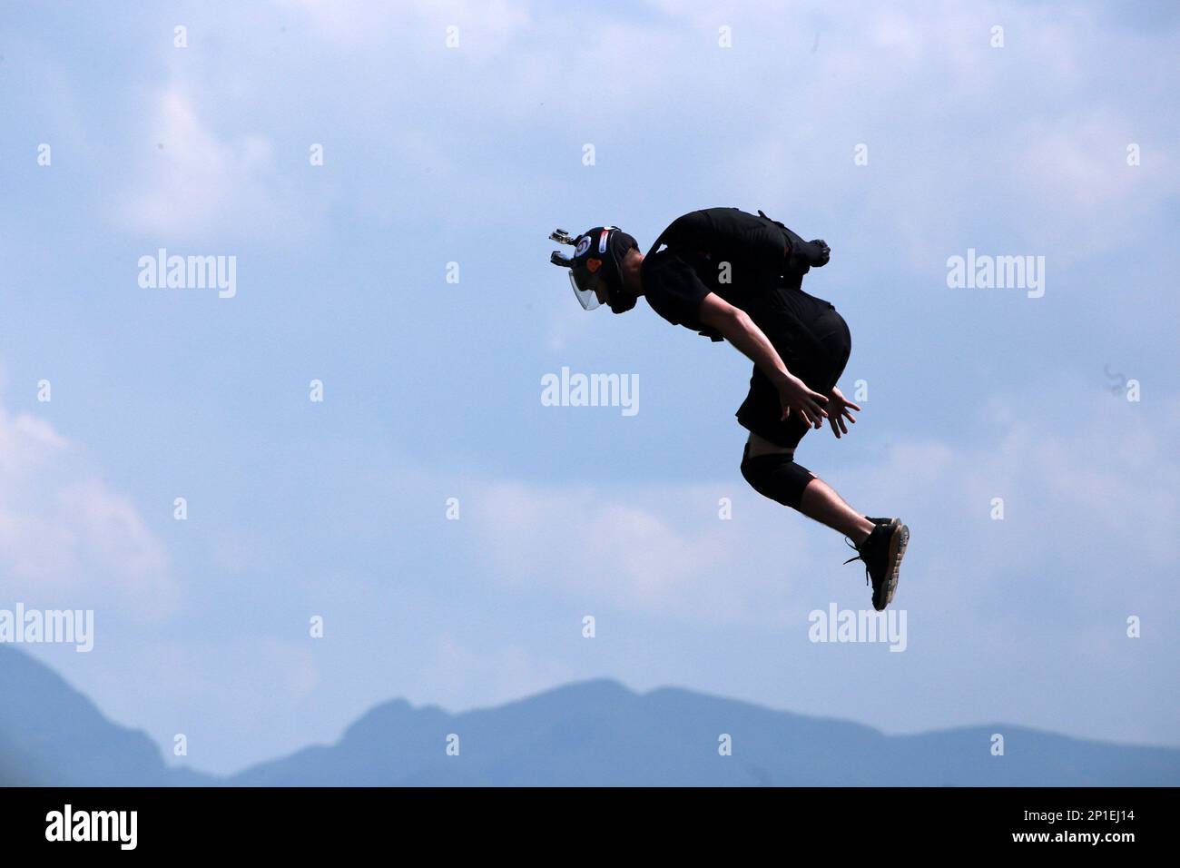 A contestant jumps off the glass cantilever bridge on the cliff during ...