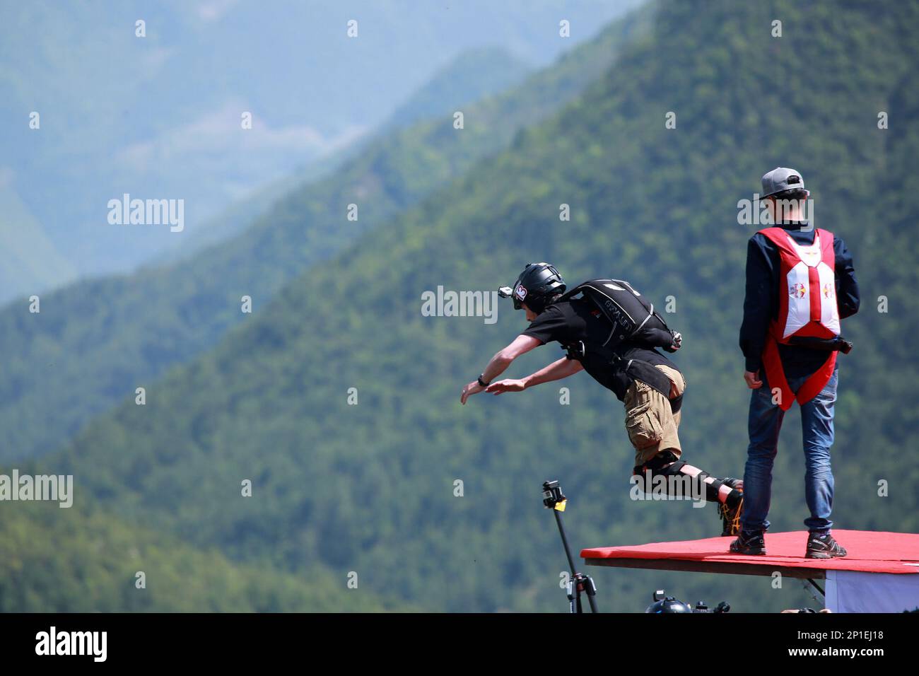 A contestant jumps off the glass cantilever bridge on the cliff during ...