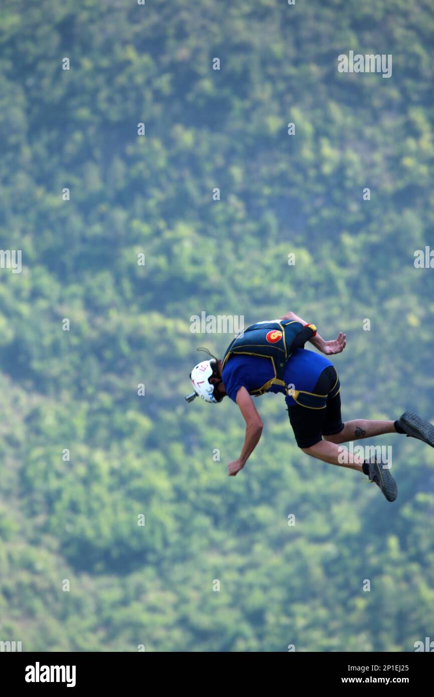 A contestant jumps off the glass cantilever bridge on the cliff during ...
