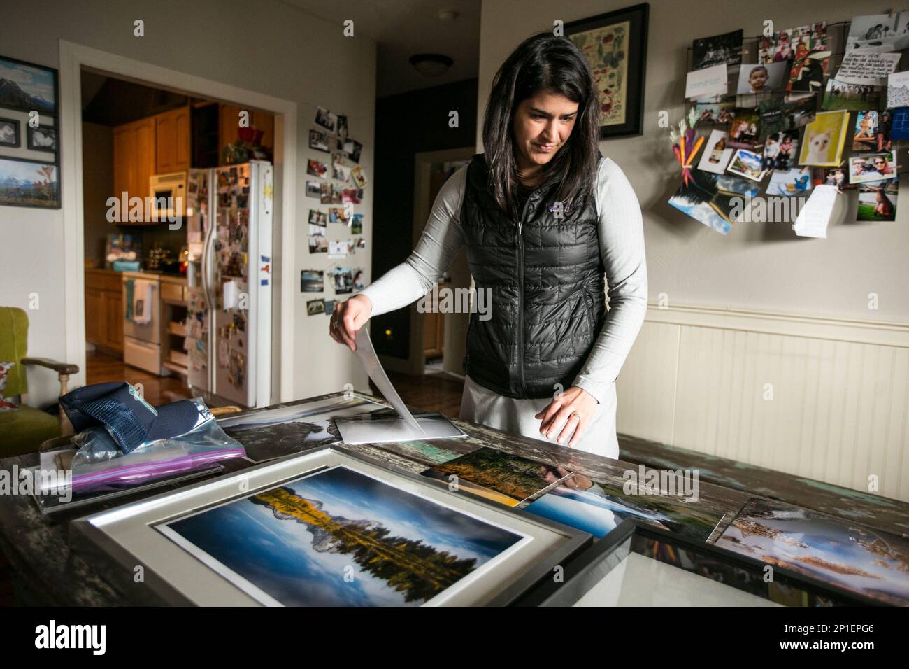 Jonell Anderson looks through photographic prints at her home in ...