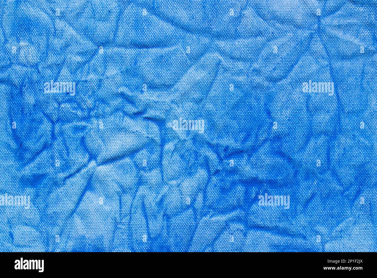 blue color painted on creased canvas background texture Stock Photo - Alamy