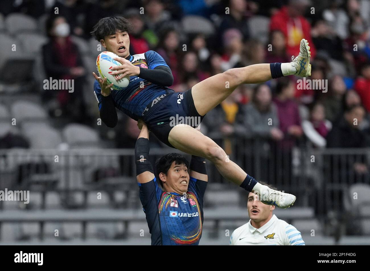 Japan's Kippei Taninaka, top, is lifted by Takamasa Maruo as he grabs ...