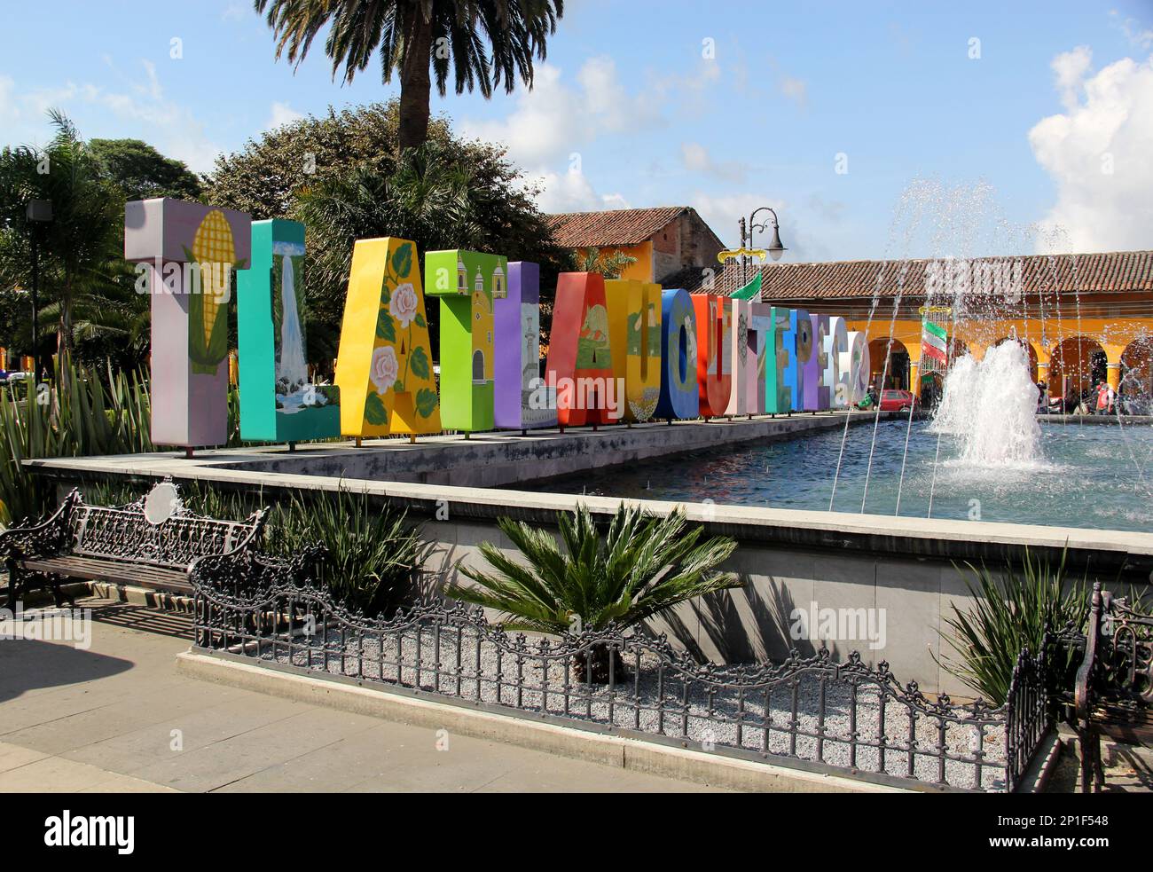 Public plaza with fountain, park bench and giant letters in ...