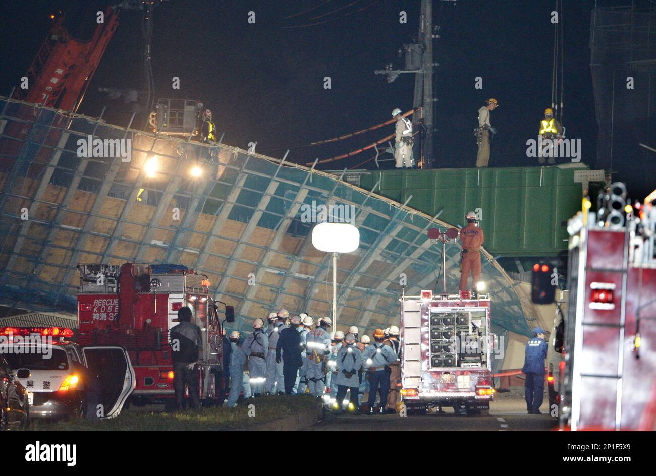 An photo shows construction workers attempting to pull up a collapsed ...