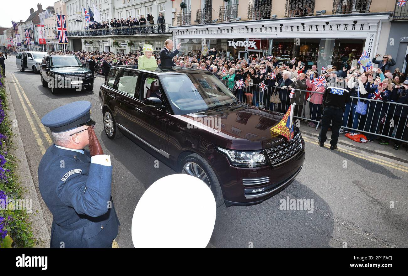 Britain's Queen Elizabeth II and Prince Philip ride in an open-topped ...