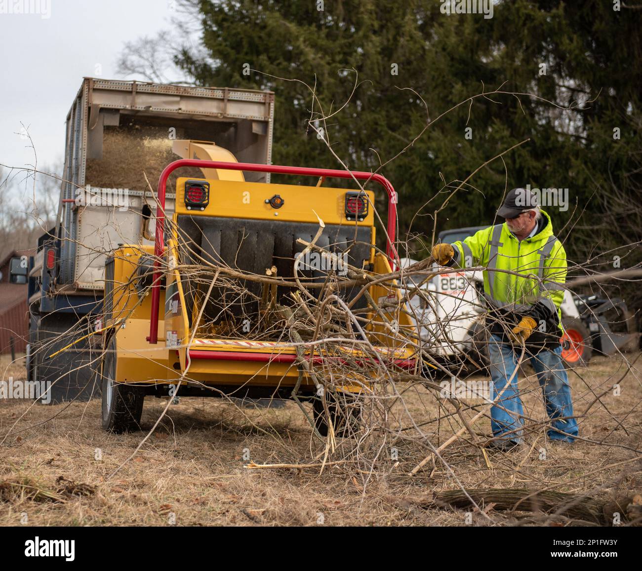 Lloyd McIntosh, 88th Civil Engineer Group tractor operator, throws tree ...
