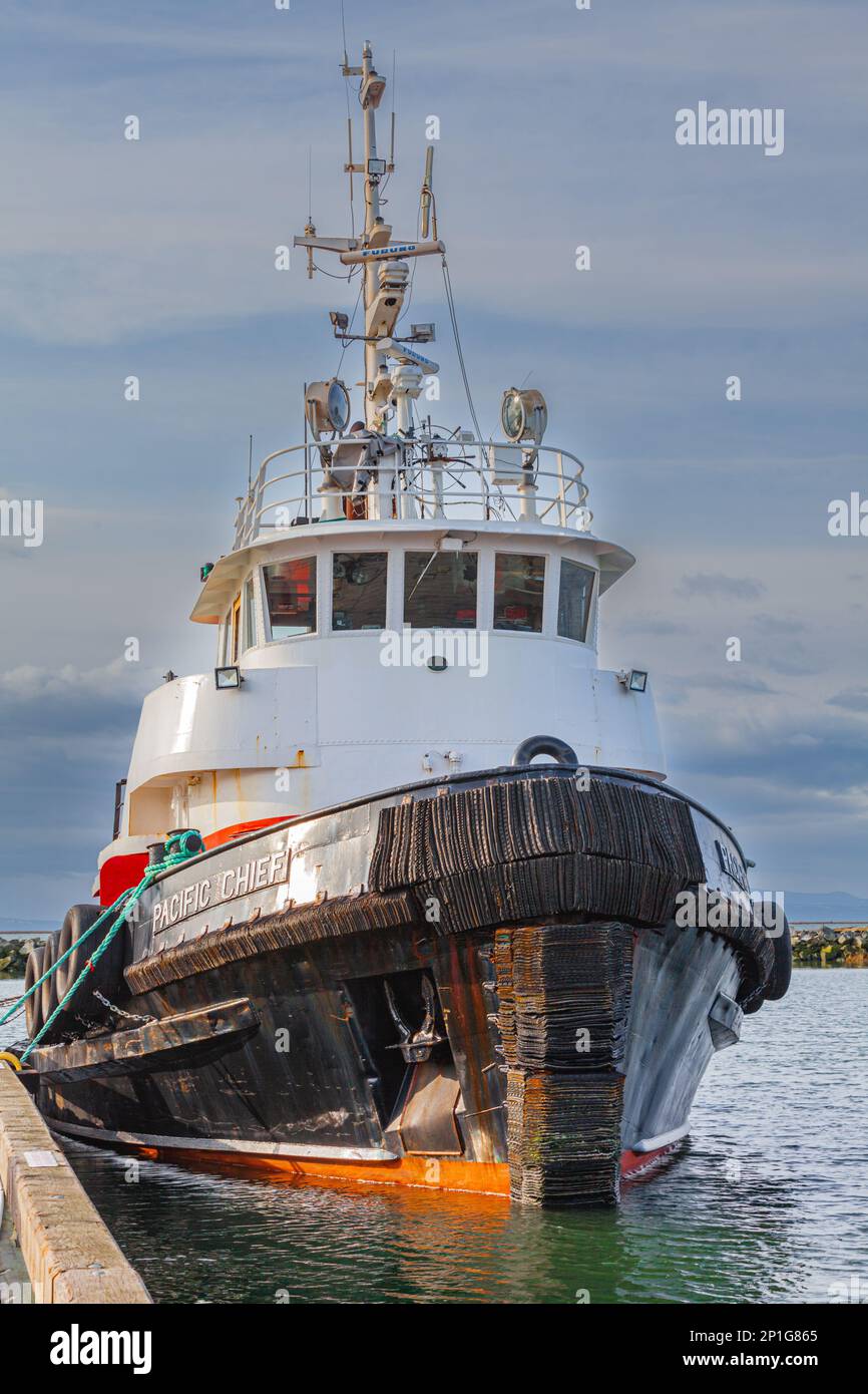 Heavy duty ocean tugboat tethered to a dock for equipment repairs in ...