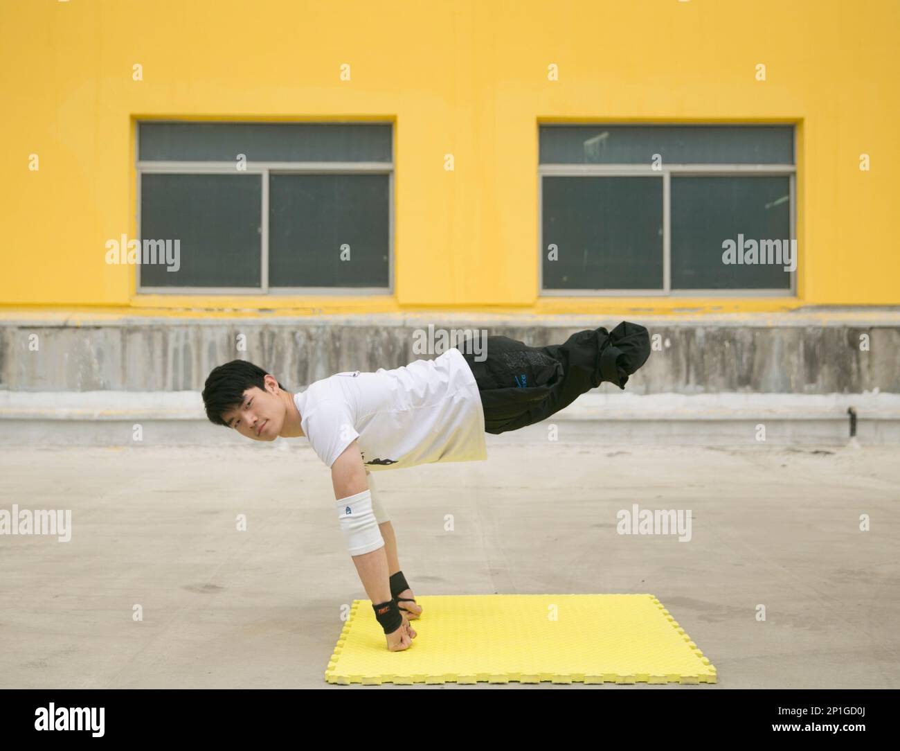 Legless Chinese man Shen Dacheng supports his body with two arms during ...