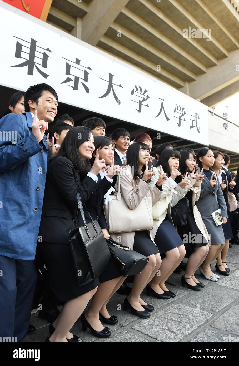 New students of the University of Tokyo, pose for a picture after ...