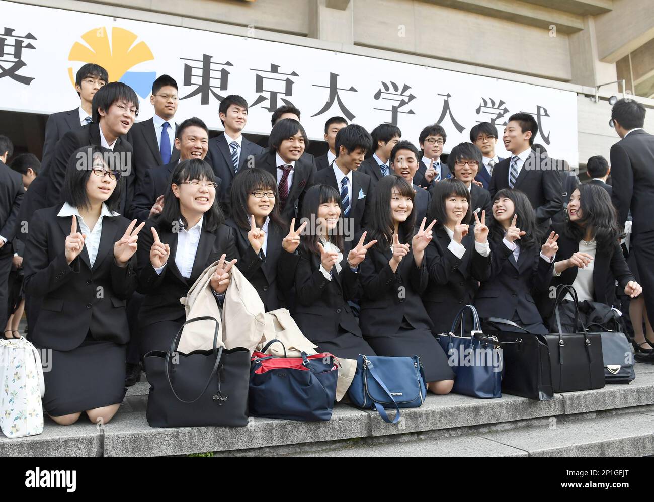 New students of the University of Tokyo, pose for a picture after ...