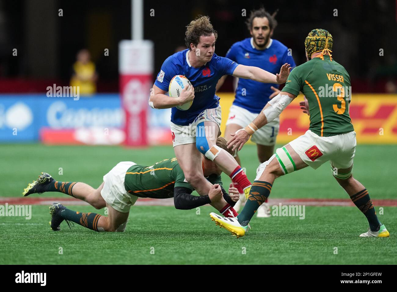 France's Paul Leraitre, centre, carries the ball past South Africa's ...