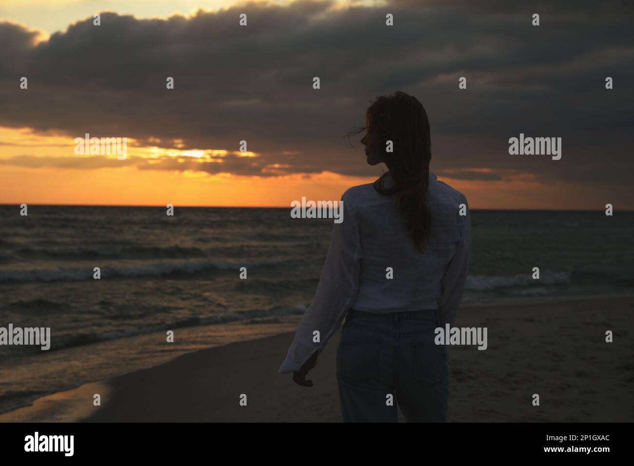 Back view woman walking sandy hi-res stock photography and images - Alamy
