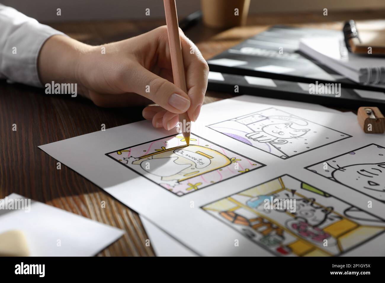 Woman drawing cartoon sketch at workplace, closeup. Pre-production ...