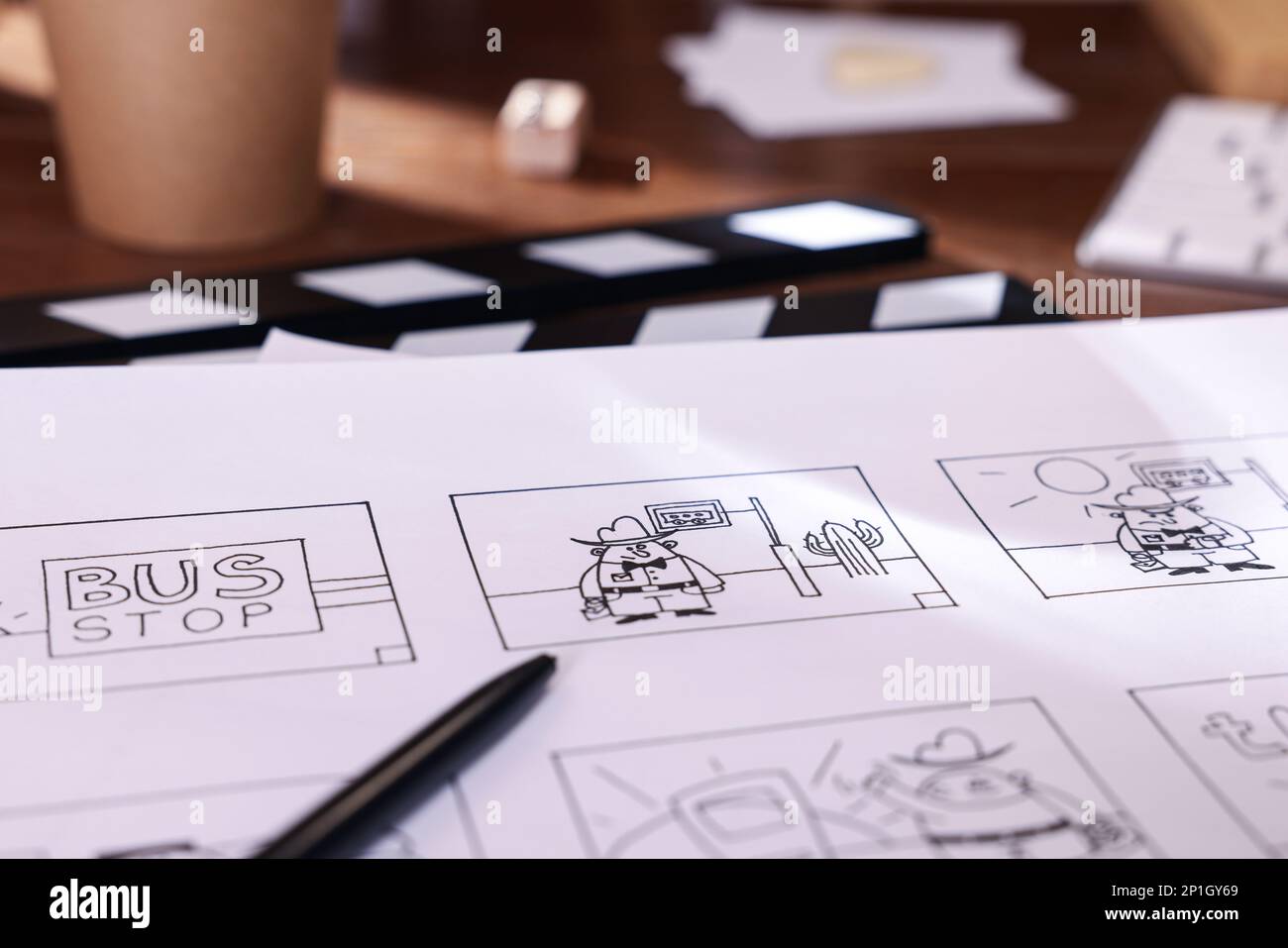 Storyboard with cartoon sketches at workplace, closeup. Pre-production ...