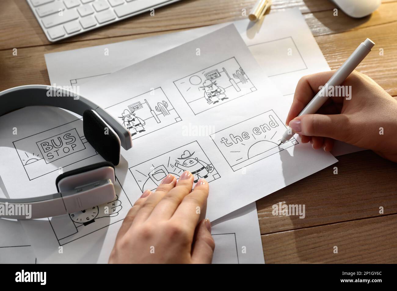 Woman drawing cartoon sketches at workplace, closeup. Pre-production ...