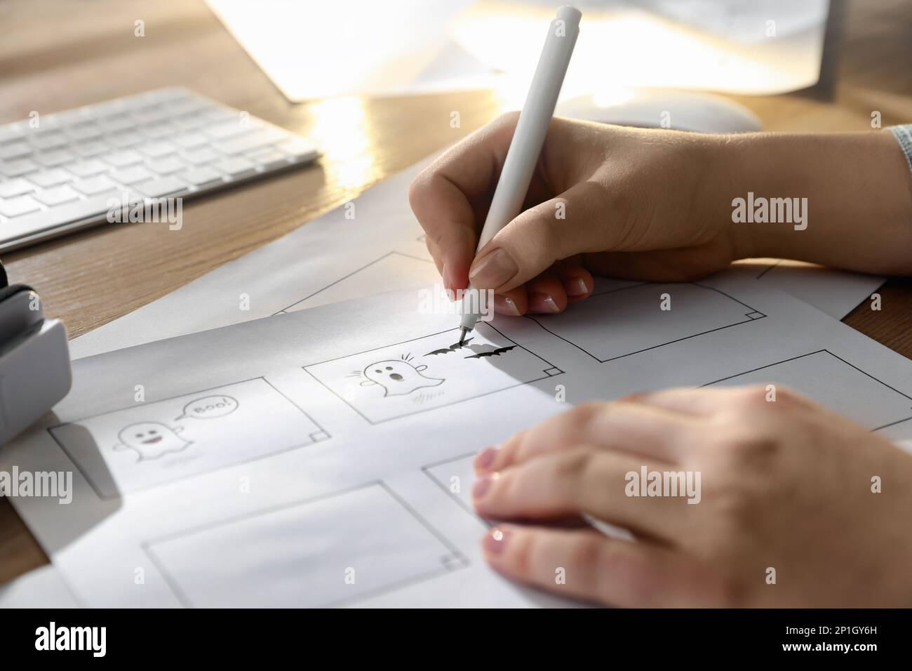 Woman drawing cartoon sketches at workplace, closeup. Pre-production ...
