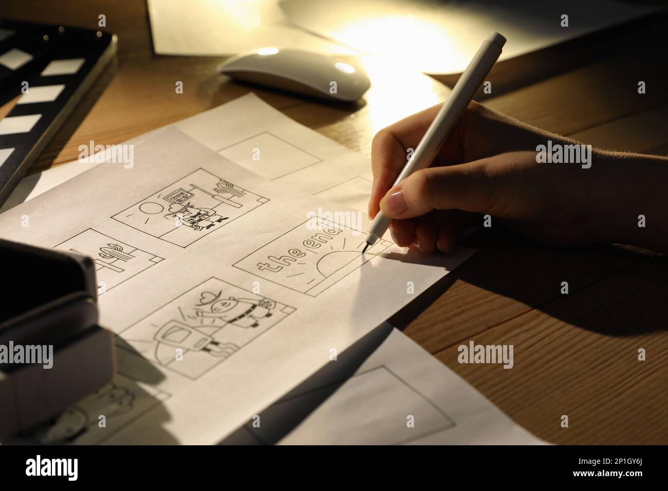 Woman drawing cartoon sketches at workplace, closeup. Pre-production ...