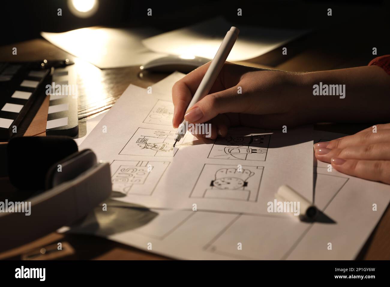 Woman drawing cartoon sketches at workplace, closeup. Pre-production ...