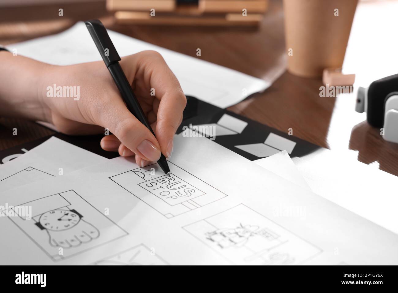 Woman drawing cartoon sketch at workplace, closeup. Pre-production ...