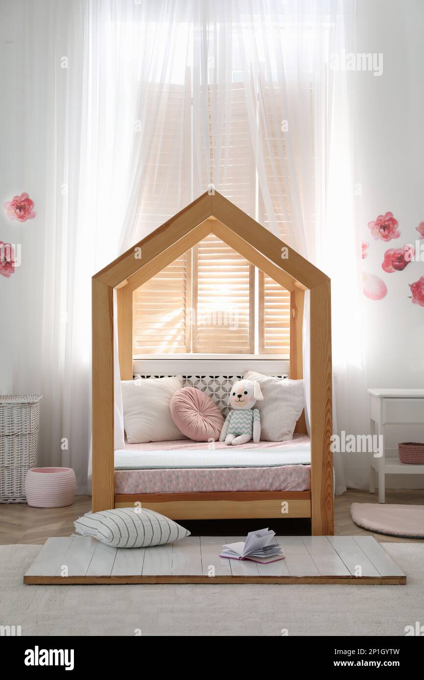 Stylish child room interior with wooden house bed Stock Photo - Alamy