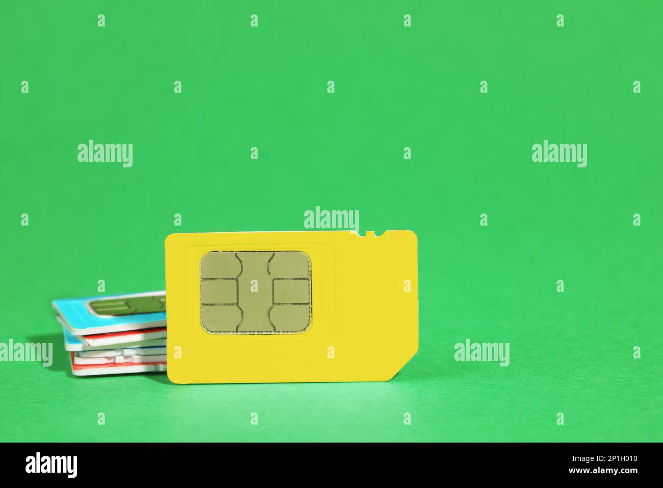 Different SIM cards on green background. Space for text Stock Photo - Alamy