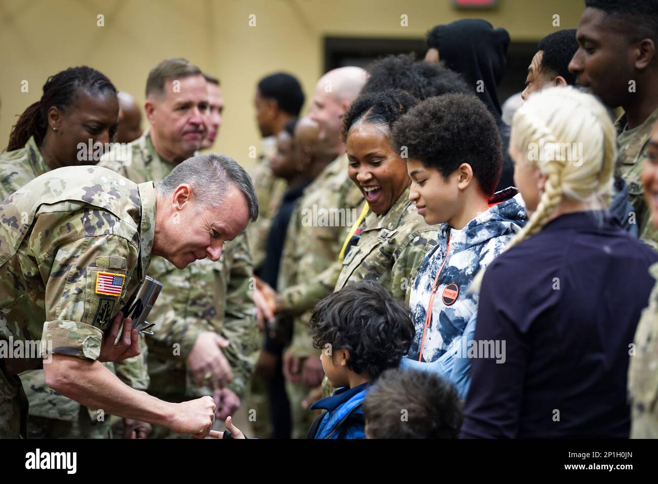 Audience members congratulate Soldiers and their families following a ...