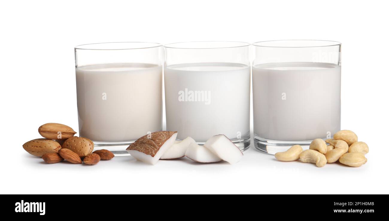Vegan milk and different nuts on white background Stock Photo - Alamy