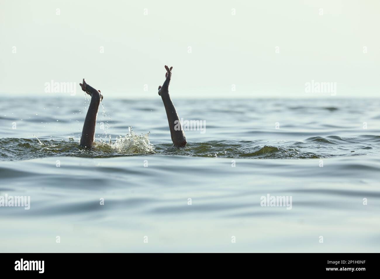 Drowning woman reaching for help in sea Stock Photo - Alamy