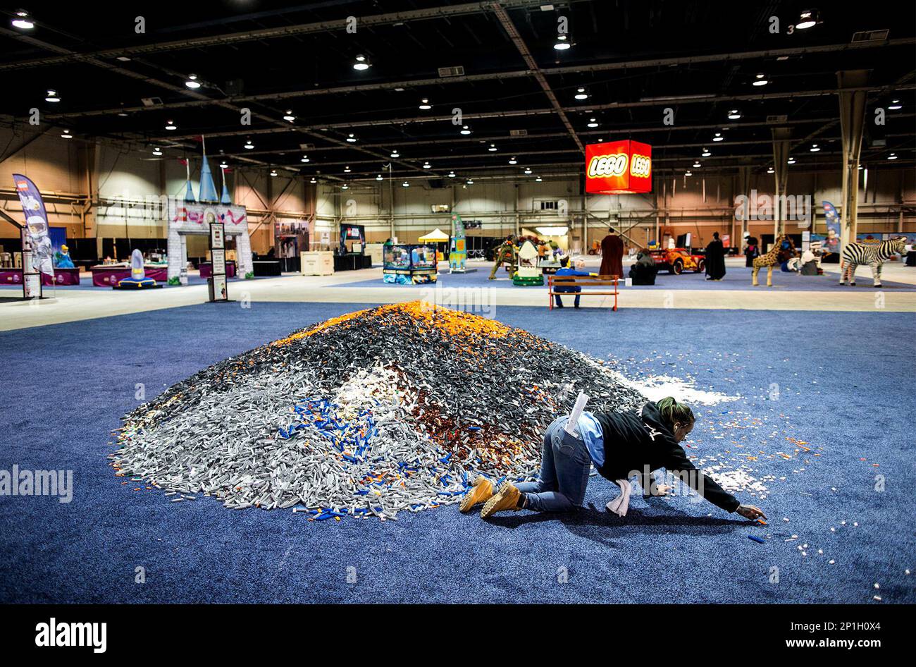 Nicole Rorie of North Carolina adds LEGOs to a large pile during setup ...