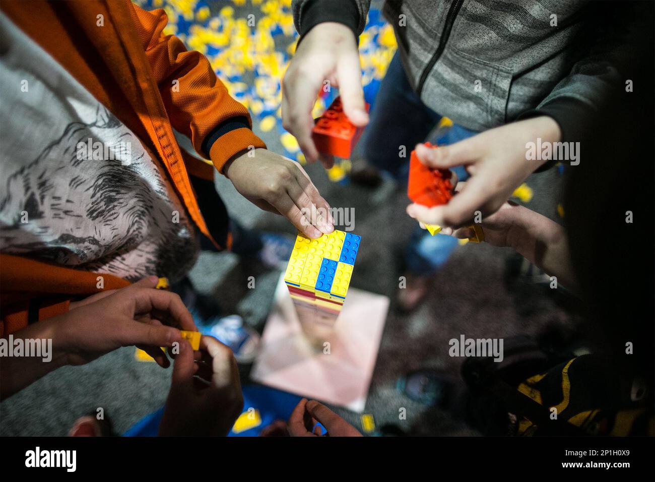 A group of boys build a LEGO tower during the LEGO KidsFest at the Farm ...