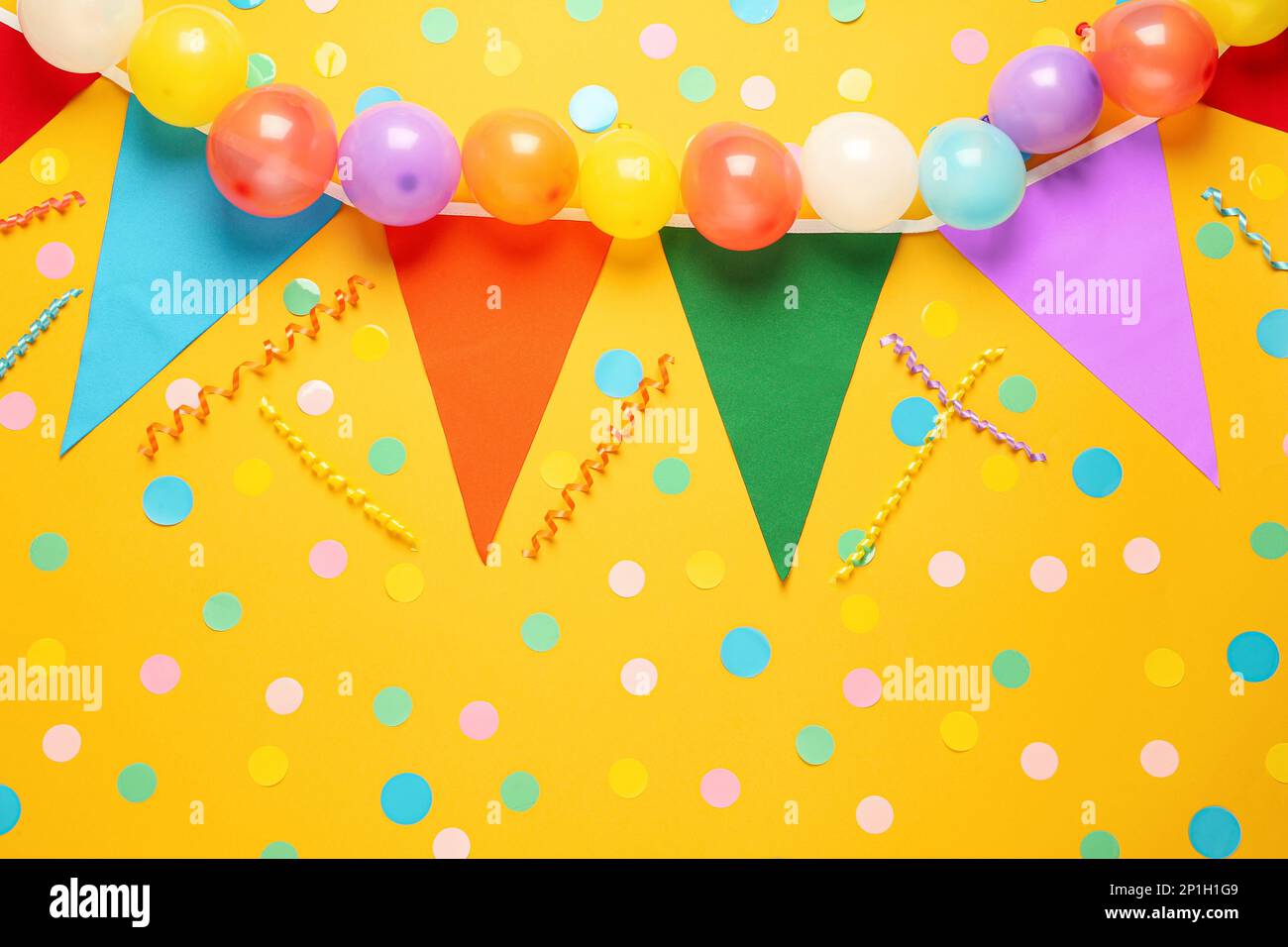 Bunting with colorful triangular flags and other festive decor on ...