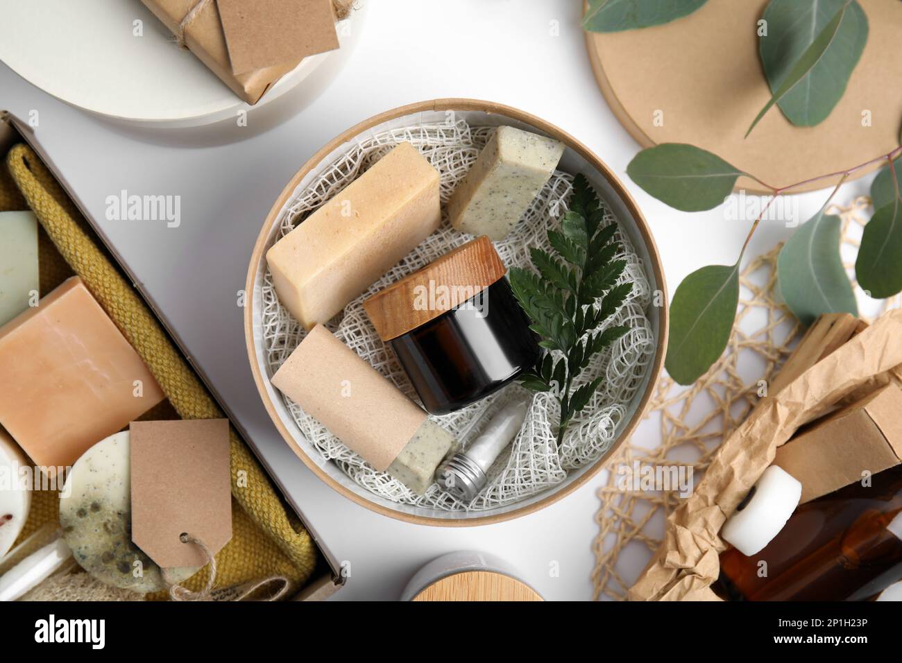 Cardboard boxes with eco friendly personal care products on white ...