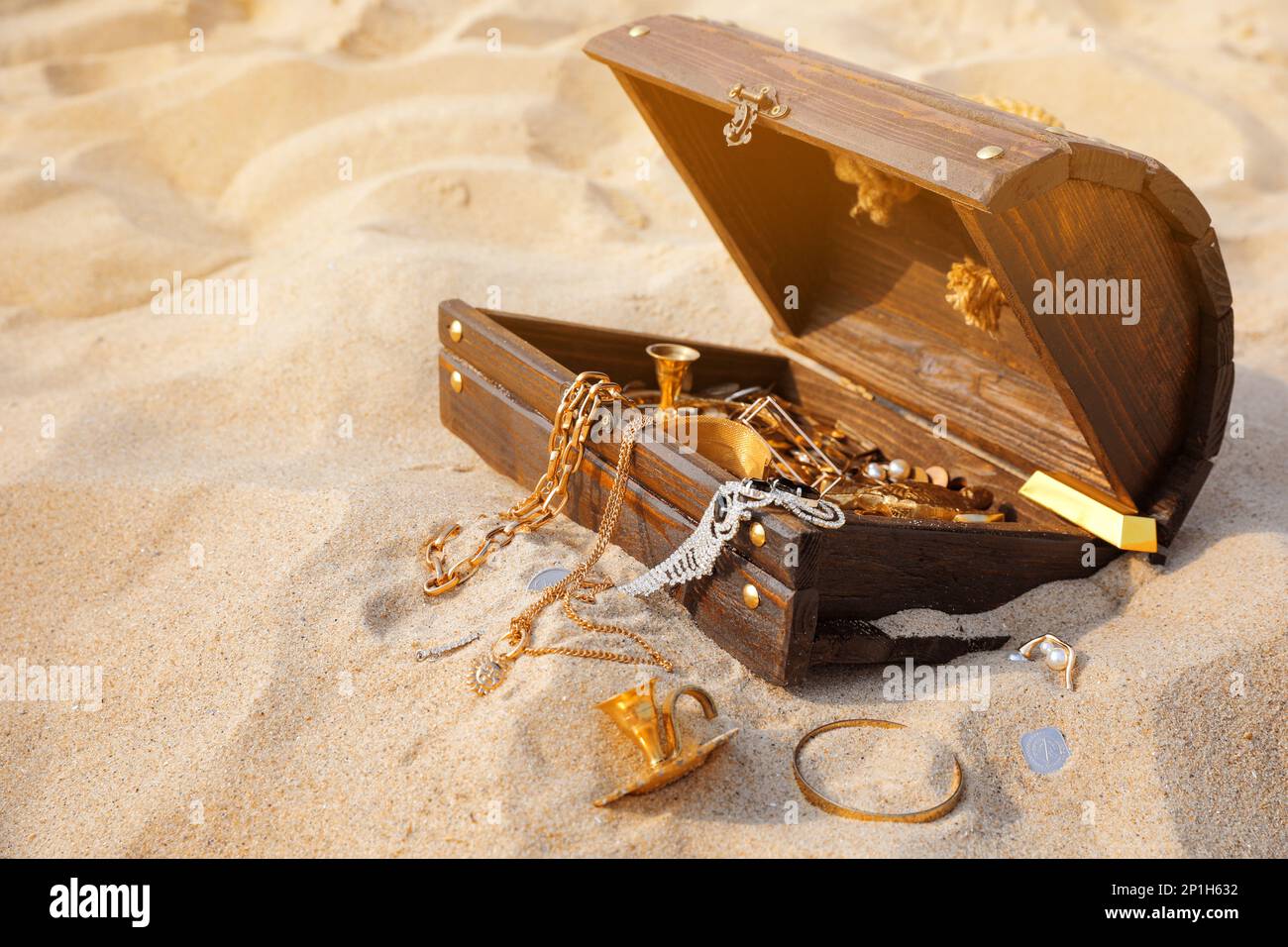 Open wooden treasure chest on sand, space for text Stock Photo - Alamy