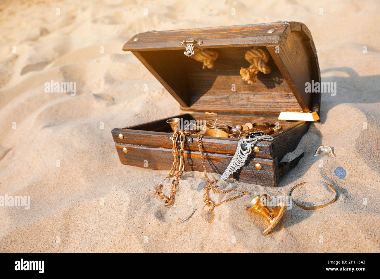 Open wooden treasure chest on sand, space for text Stock Photo - Alamy